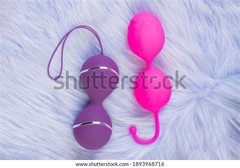 Collection Of Different Types Pink And Violet Vaginal Balls Sex Toys On Violet Background Sex