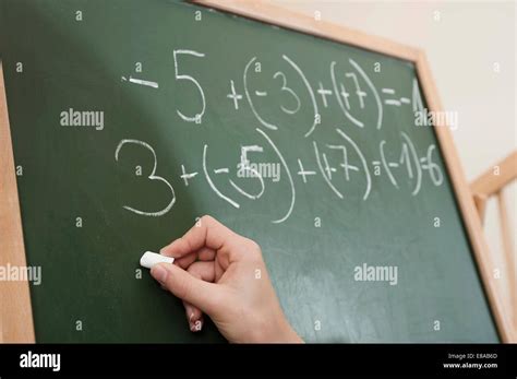 Girl Writing Arithmetic Problem On Blackboard Stock Photo Alamy