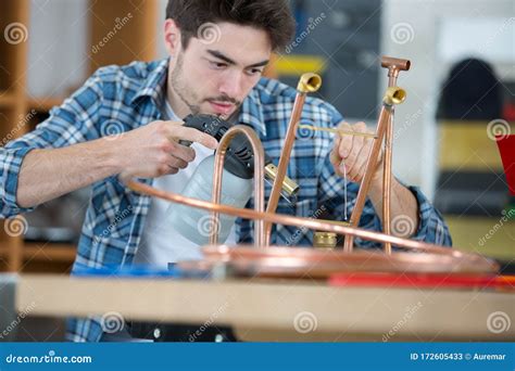 Young Worker Using Propane Gas Torch For Soldering Copper Pipes Stock Image Image Of Plumber
