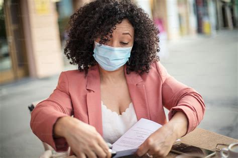 일만 카페에서 문서 작업을 하는 보호용 안면 마스크를 쓴 사업가 사진 Unsplash의 바깥 이미지