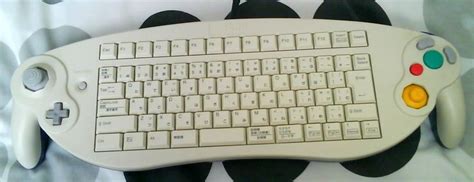 a beautiful hilarious gamecube controller with a full ascii keyboard