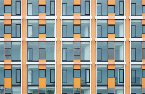 modern building facade features regular pattern of windows orange
