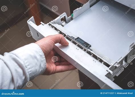 Working With An Office Printer Male Hand Closes The Printer S Paper Tray Loading Paper In The