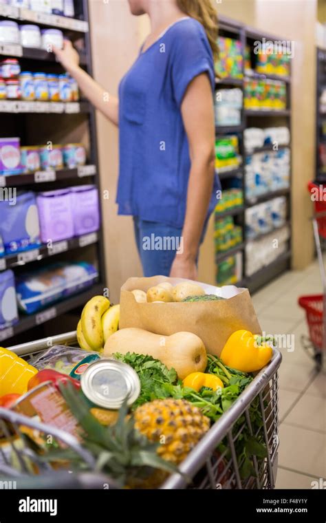 Casual Woman Taking Product On Shelf Stock Photo Alamy