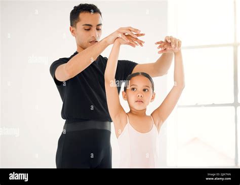 Practicing For Her Upcoming Ballet Concert A Ballet Teacher Assisting