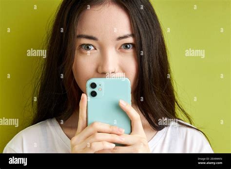 Young Woman Hiding Secret Information Message In The Smartphone