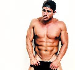 Hunt Muscular Model In Black Cap Holding Black Underwear Over His