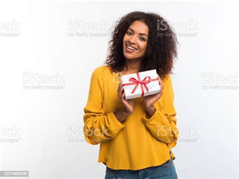 빨간 리본 및 활 흰 벽 바탕에 선물 상자를 들고 노란색가 상단에 귀여운 흑인 젊은 여자 여자 그녀는 현재 행복 선물에 대한 스톡 사진 및 기타 이미지 Istock