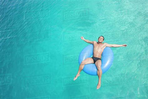 Hispanic Man On Float In Water Stock Photo Dissolve