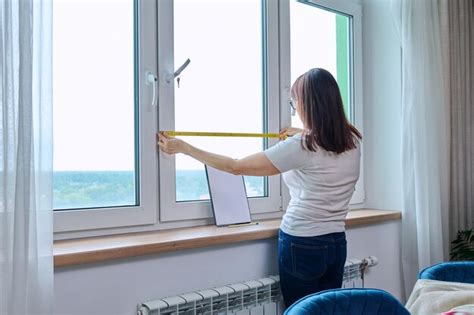 Premium Photo Woman Measuring Window With Tape Measure Tailoring Service