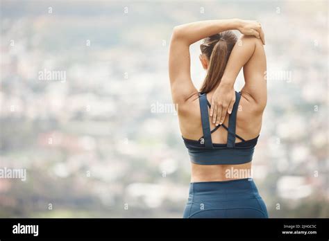 One Active Mixed Race Woman From The Back Stretching Arms And Triceps