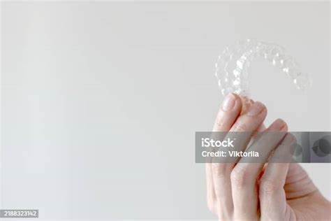 복사 공간이 있는 흰색 배경에 Invisalign 투명 교정기를 들고 있는 손 보이지 않는 교정장치 및 교정장치 구별하기 힘든에 대한 스톡 사진 및 기타 이미지 Istock