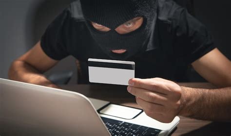 Premium Photo Hacker With Credit Card And Laptop Computer Cyber Crime
