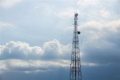 5g Telecom Signal Tower Telecommunication Tower On Blue Cloudy Storm Sky For Background