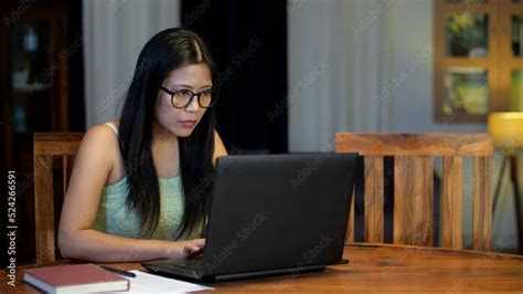 Female Professional Wearing Eyeglasses Working On Laptop Typing On The Keyboard Office Work
