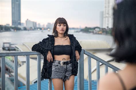 Two Beautiful Asian Girls Having Fun On The Bridge By Stocksy