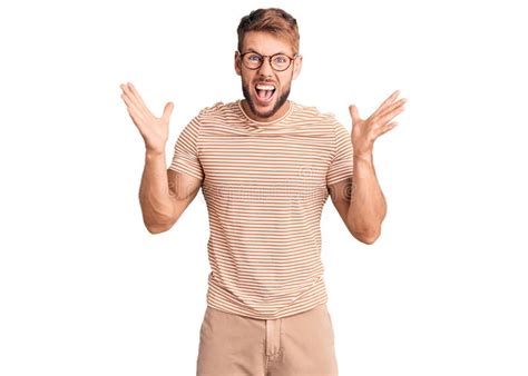 Young Caucasian Man Wearing Casual Clothes And Glasses Celebrating