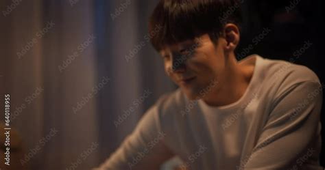 Korean Young Father Caring For His Cute Son Putting Him To Sleep In