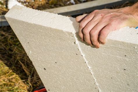 Installing Rigid Styrofoam Insulation Board For Energy Saving Of The House Wall Stock Image