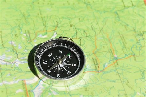 Premium Photo Navigation Using A Map And Compass