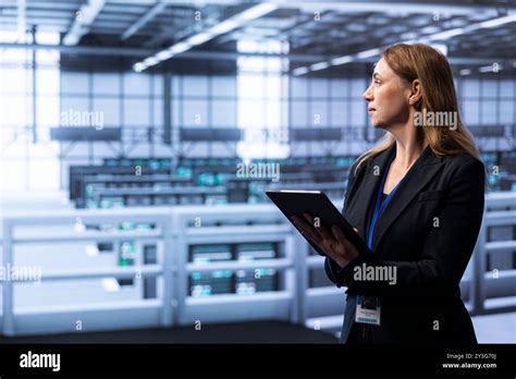 Computer Scientist Walking Between Server Rows In Data Center Doing Yearly Infrastructure