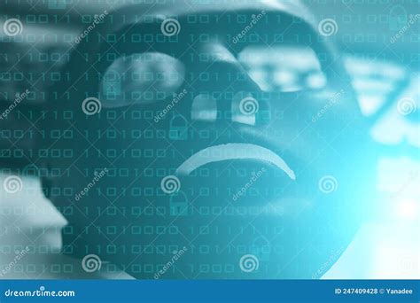 The Hacker In A Mask Hacks The Computer System Zeros And Ones Are Shown On The Screen Royalty