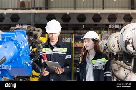 Both Of Engineers Working Together In A Robotic Arm Factory Robotic Arm Industry And