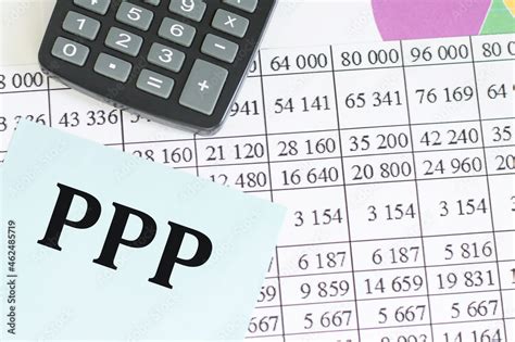 Ppp Text On A Blue Card On The Table Next To A Calculator And Paper With Numbers And Diagrams