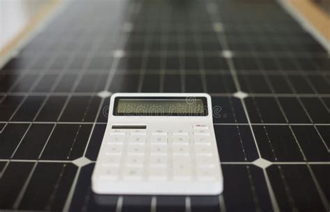 Calculator On Photovoltaic Solar Panel Illustrating Concept Of