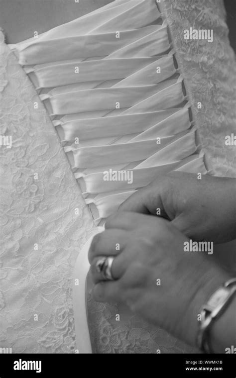 Brides Dress Being Laced Up On Her Wedding Day By Her Mother Just Before She Heads Off To Her