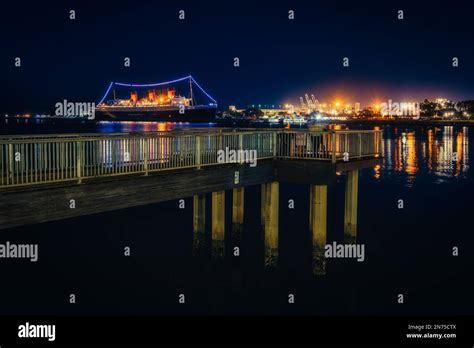 A Night View Of Shoreline Village Pier With Illuminated Buildings And