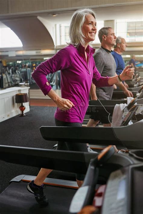 Sports Cardio And Mature Woman On Treadmill In Gym For Health Wellness And Body Exercise