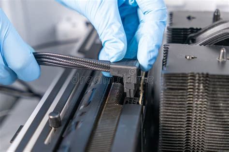 Technician In Blue Gloves Connecting 16 Pin Power Cable To Modern Gpu Inside Desktop Computer