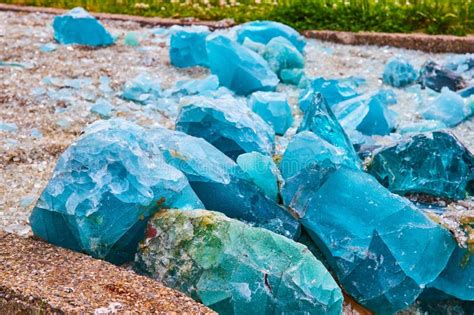 Beautiful Blue Glass Shards Sitting In Pile Of White Glass Fragments In A Road Of Glass Stock