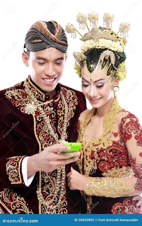 Happy Traditional Java Wedding Couple With Mobile Phone Stock Image