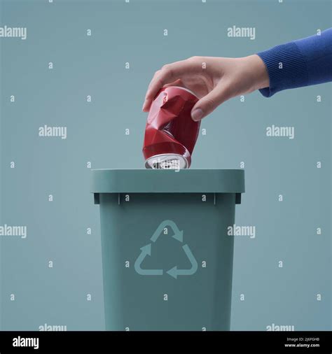 Woman Putting A Can In A Garbage Bin Separate Waste Collection And Recycling Concept Stock