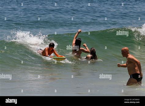 People At Beach Beachgoers Swimming And Sunbathing Near Shore On Sunny