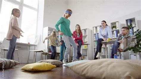 Low Angle Full Shot Of Blindfolded Teenage Girl Carefully Moving Around