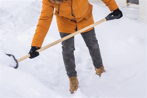 Premium Photo Man Cleaning Snow From Sidewalk And Using Snow Shovel Winter Season