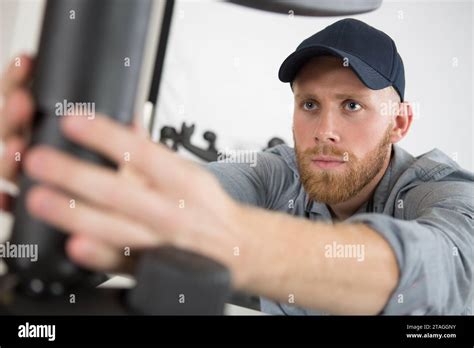 Concentrated Man Fixing A Chair Stock Photo Alamy