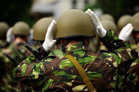 Soldiers In Camouflage Uniform With Hands On Their Backs Stock Image
