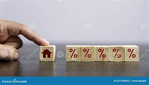 Hand Building A House By Wooden Cubes With The Percentage Sign On Them