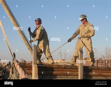 Us Navy Equipment Operator 1st Class Left And Construction Electrician 2nd Class Moves A