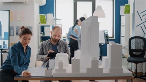 Premium Photo Man And Woman Analyzing Building Model And Maquette With Digital Tablet For