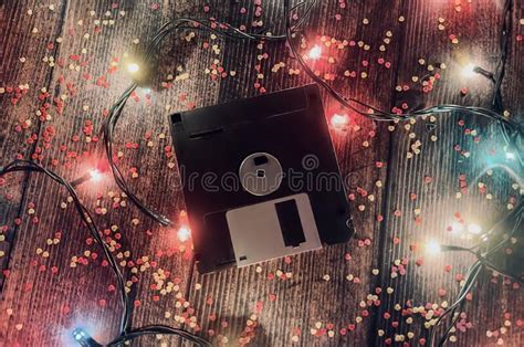 Used Floppy Diskette With Multi Colored New Year S Lights On Wooden Table Stock Image Image Of