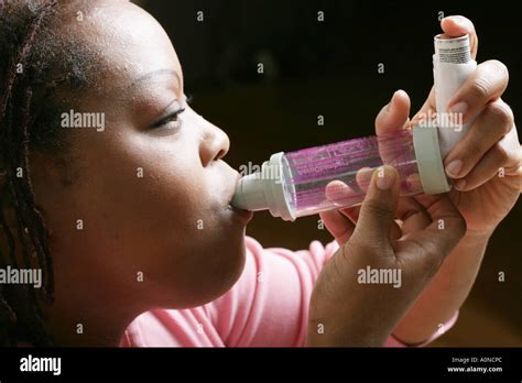 Woman With Asthma Uses An Asthma Inhaler Stock Photo Alamy