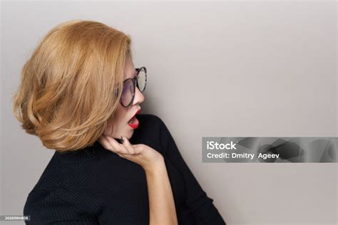 Blonde With Short Hairstyle With Glasses Red Lips Black Jacket Light Background Cropped View