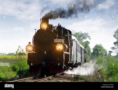 Old Passenger Train Running On Tracks Through The Forest Retro