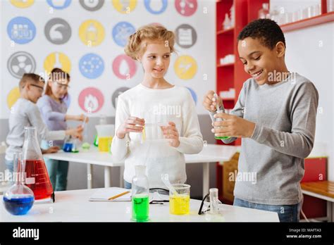 Cheerful Babe Adding Chemical To Flask During Chemistry Class Stock Photo Alamy