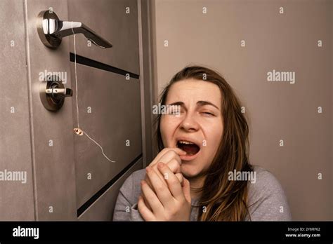 The Girl Is Holding A Thread To Pull Out A Tooth Extraction Of A Tooth In An Adult Dental Care